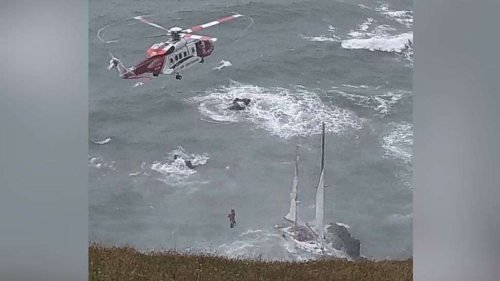 Two rescued as boat hit rocks in poor weather near Salcombe - BBC News