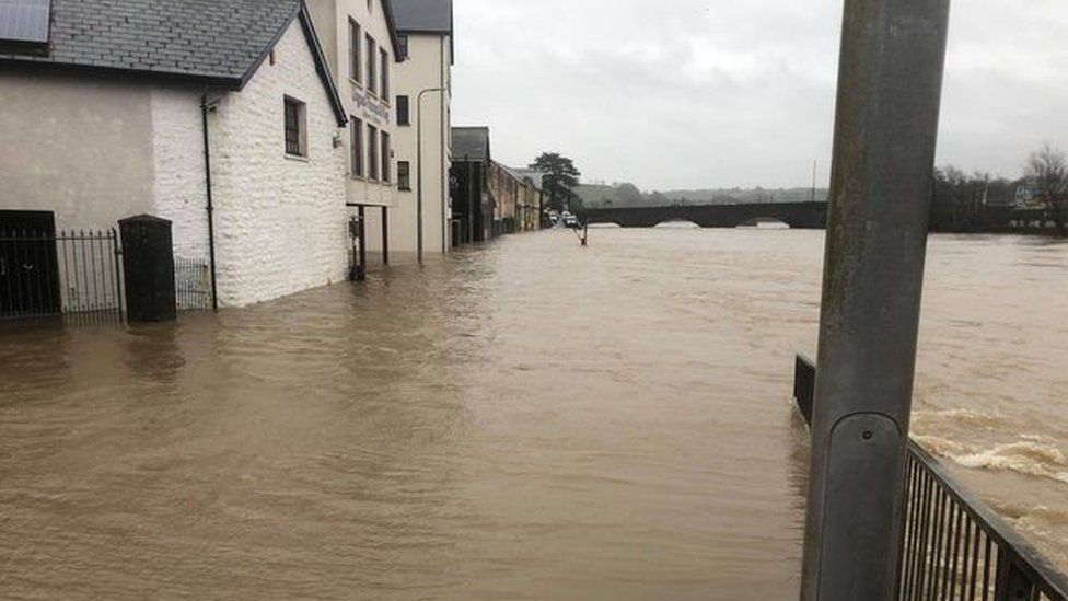 Wales flooding: Roads blocked and homes evacuated - BBC News