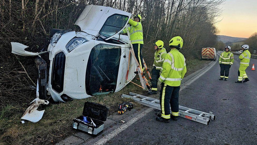 Man arrested after van flipped on its side - BBC News