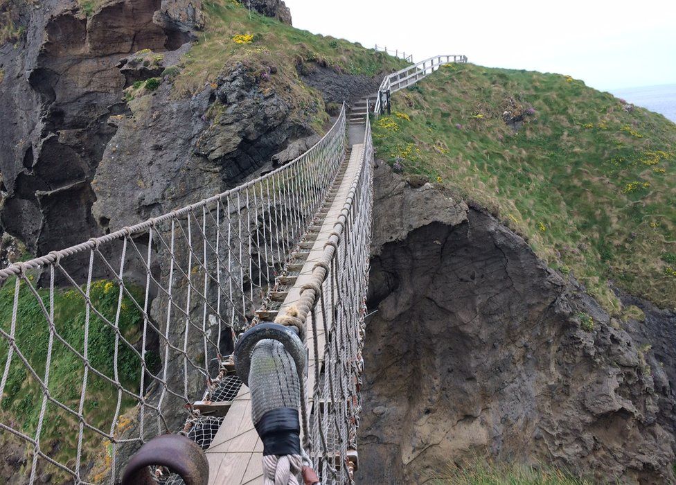 Carrick-a-Rede rope bridge reopens following vandalism - BBC News