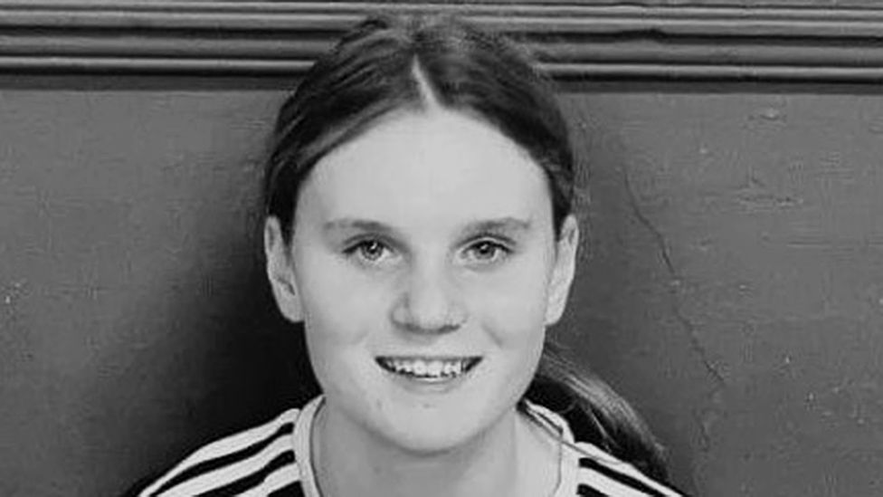 Holly Newton: Mourners gather for purple-themed vigil - BBC News