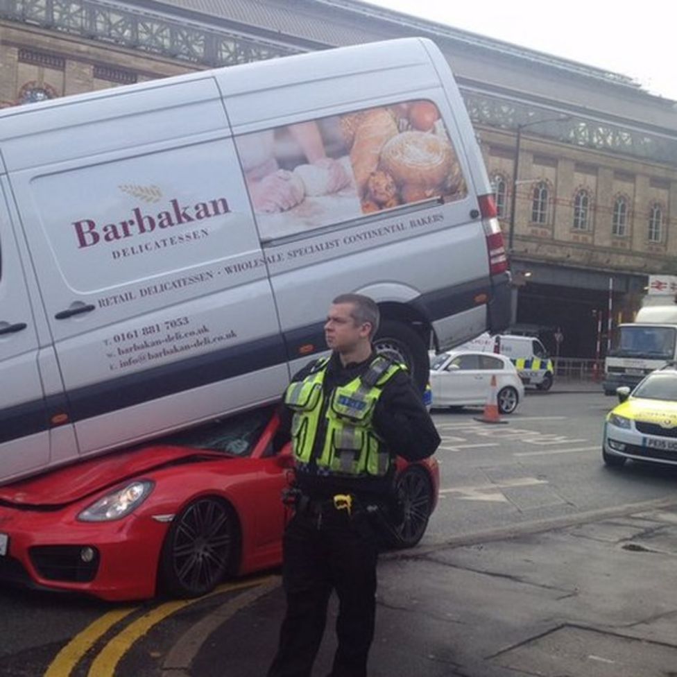 Two hurt after Manchester crash leaves car wedged under van - BBC News