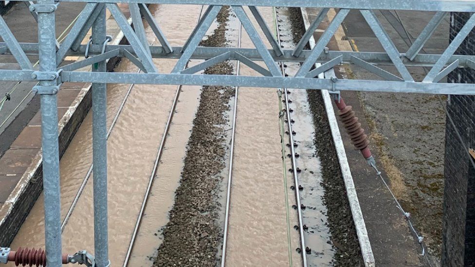 Trains stopped as burst water main floods Audenshaw railway - BBC News
