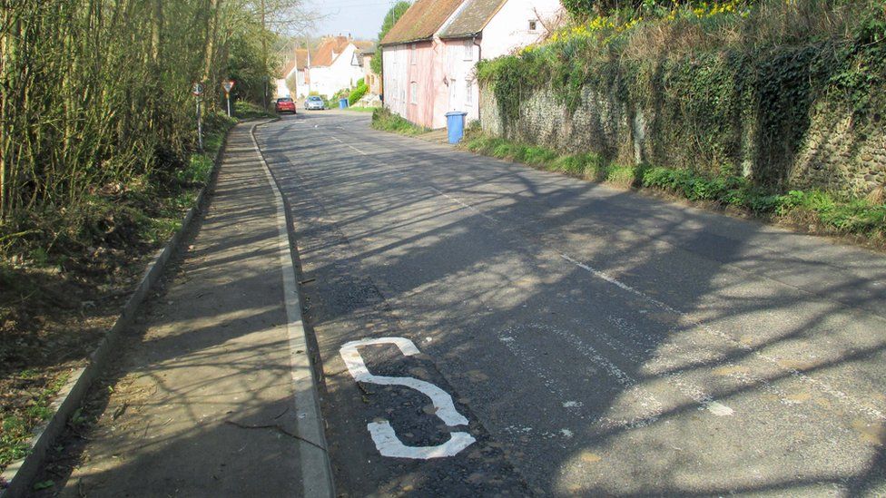 Half of word SLOW 'outside permitted area' on Boxford road - BBC News