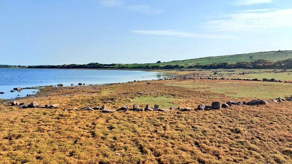 Dry weather exposes treasures below Stithians Reservoir - BBC News