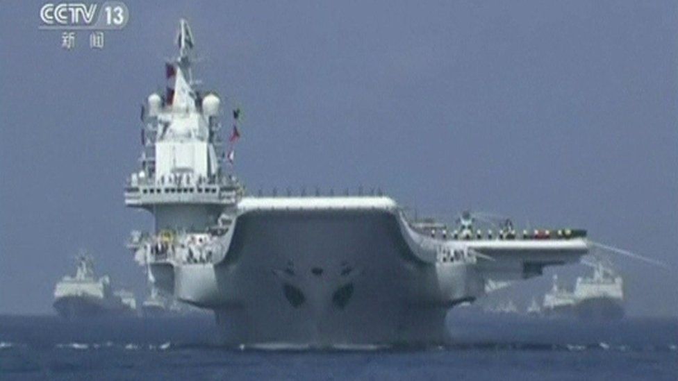 South China Sea: Xi Jinping attends massive naval display - BBC News