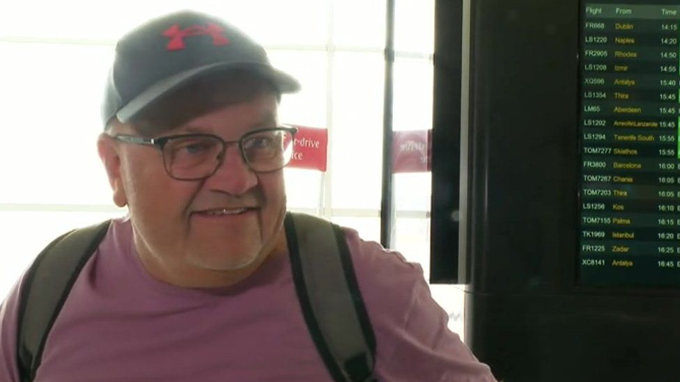 Rhodes fires: Evacuated tourists arrive in Birmingham - BBC News