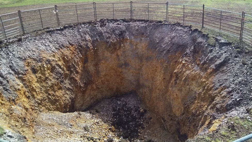 Large sink-hole opens up on Dorset coast path - BBC News