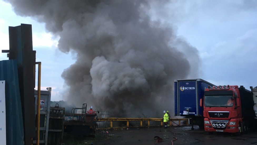 Fire crews called to large scrap yard blaze near Skewen - BBC News