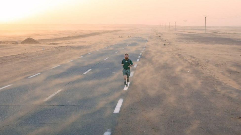 Soft Play: Finish line gig for man running length of Africa - BBC News