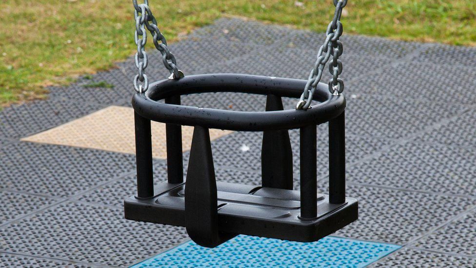 Woman stuck in Telford child's swing cut free by firefighters - BBC News