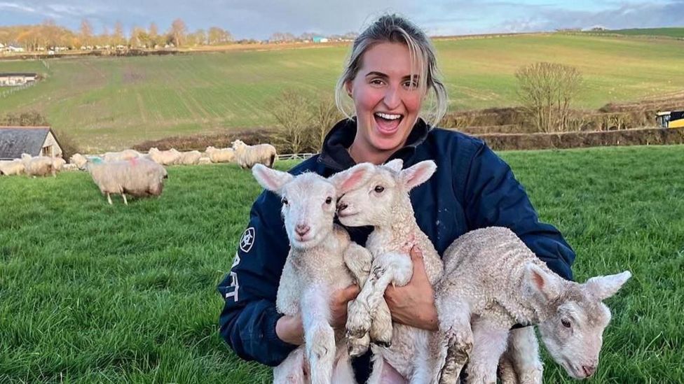 Farming influencer Natalie Davies kayaks on flooded land - BBC News