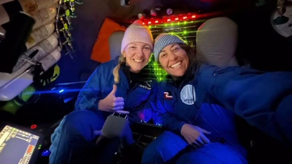 Woman breaks world record in deepest dive by all-female-crew - BBC News