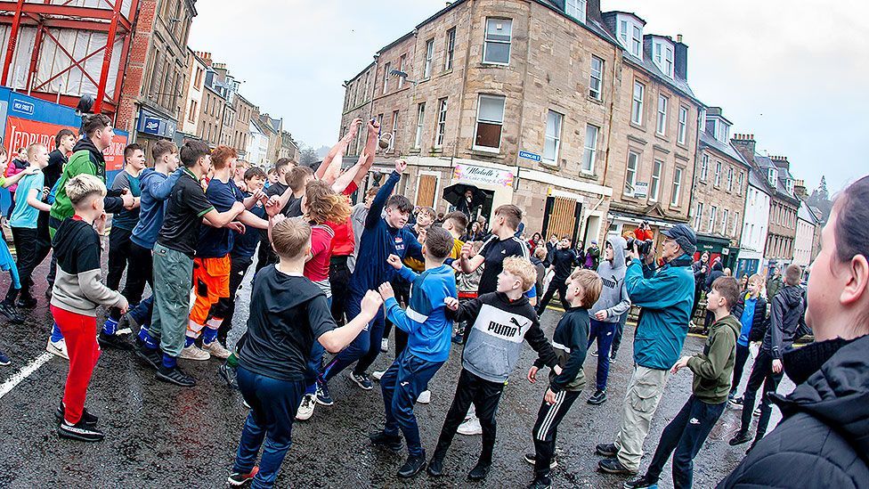 In pictures: Jedburgh ba' game takes to the streets - BBC News