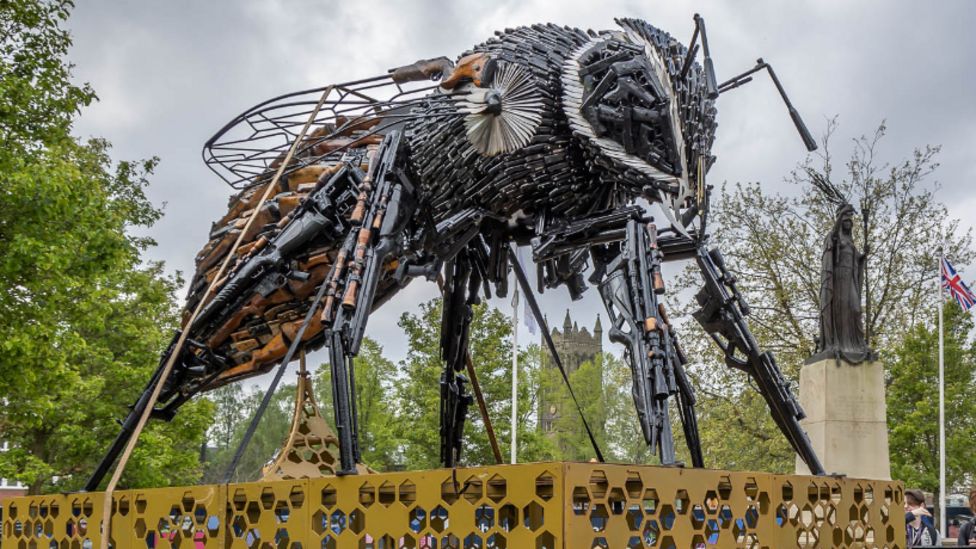Crewe town centre hosts bee sculpture made of weapons - BBC News