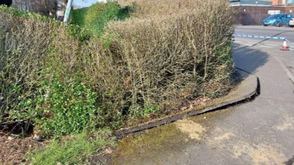 Traffic cone cemented inside Wisbech footpath causes stir - BBC News