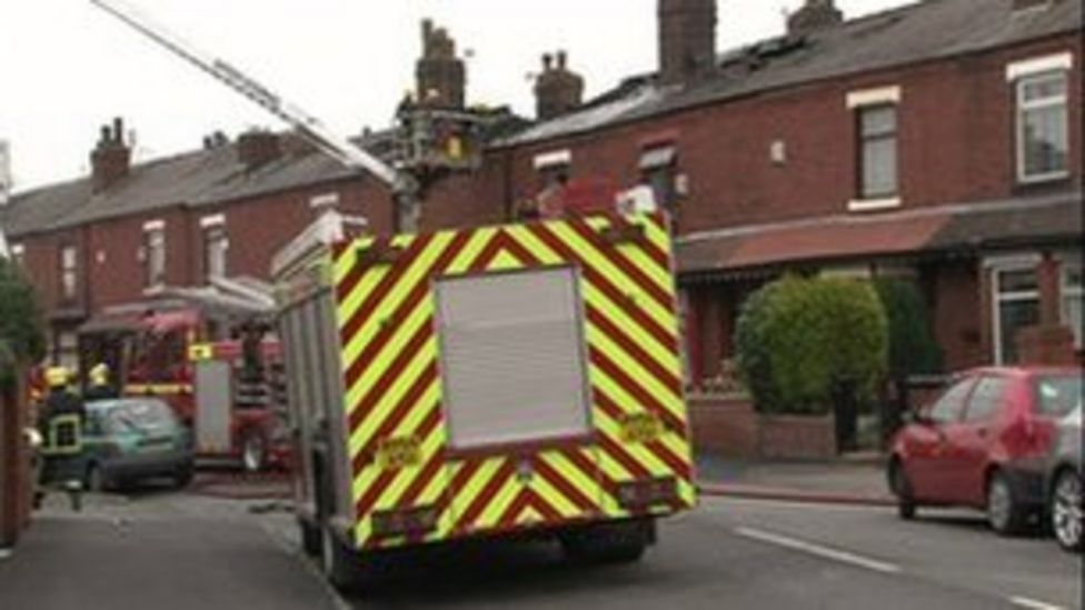 Houses evacuated after roof fire in Wigan - BBC News