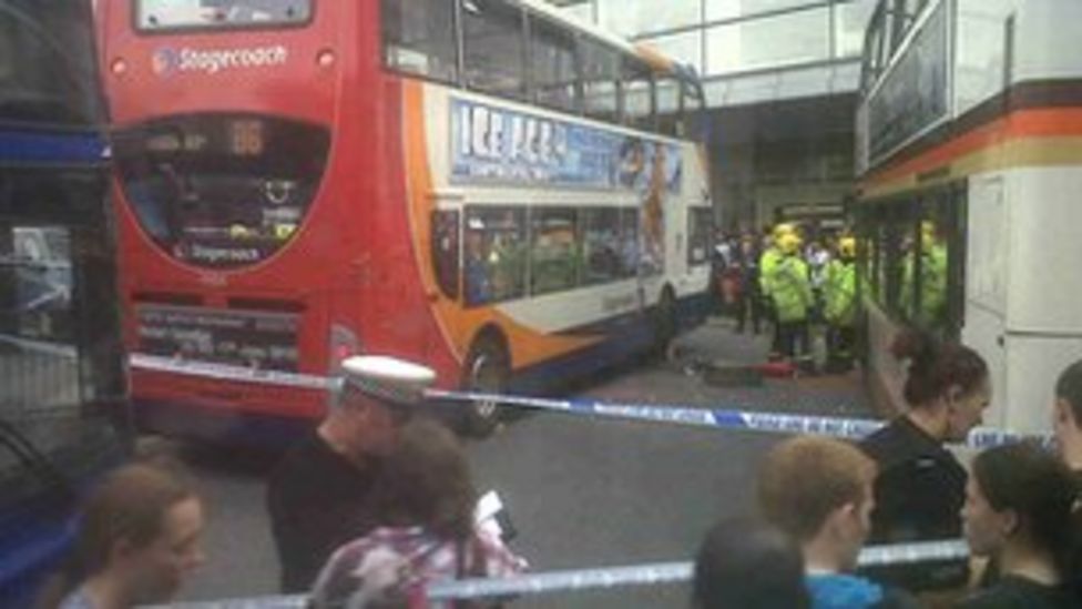 Woman, 84, trapped under Manchester bus and critically hurt - BBC News