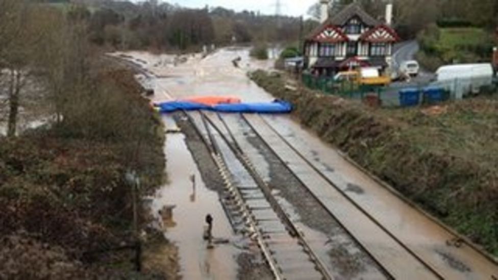 Floods: Woman saved from Devon river - BBC News
