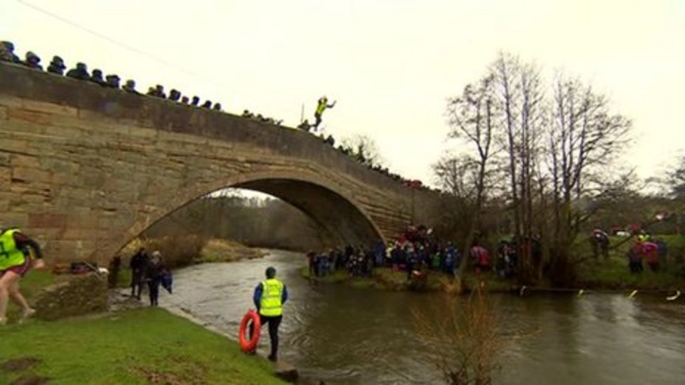 Mapleton Bridge jump: People take part in Ashbourne tradition - BBC News