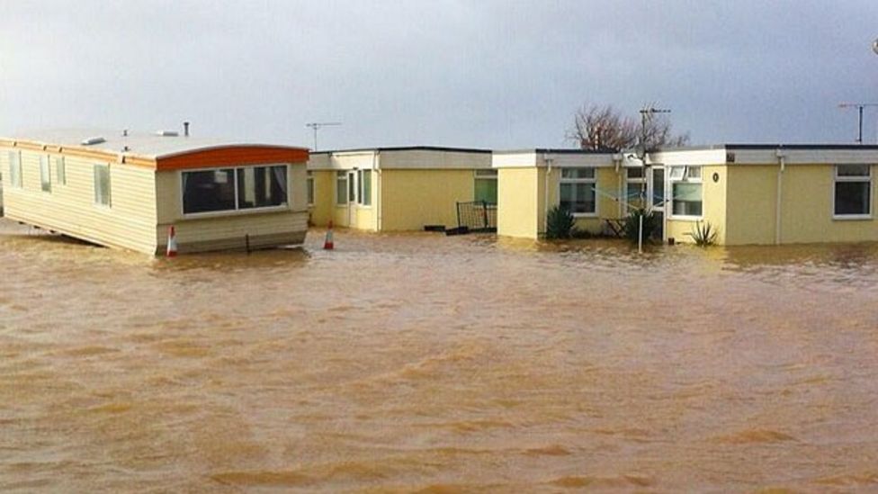 Storm surge brings flooding chaos moving up Wales' coast - BBC News