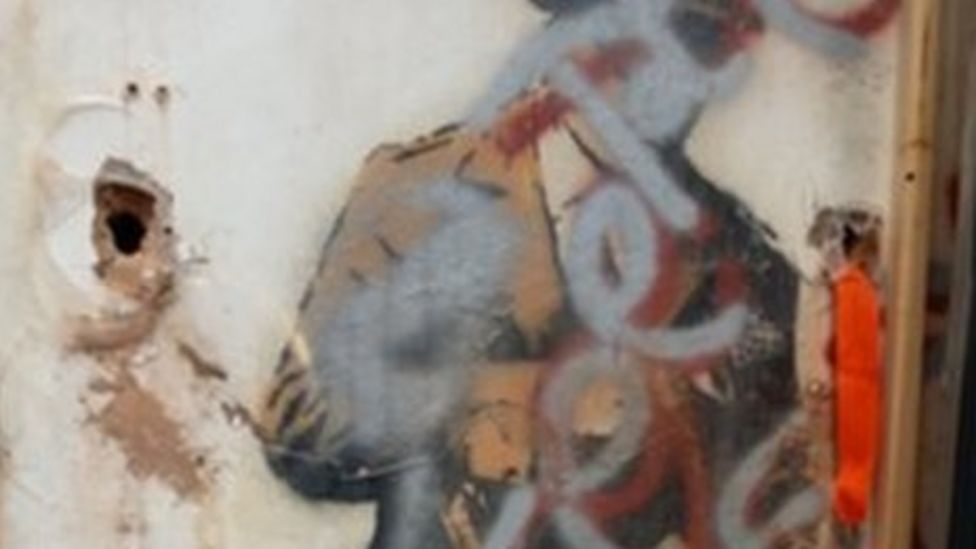 Banksy 'Spy Booth' mural in Cheltenham gets protection - BBC News