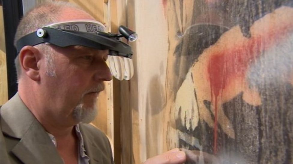 Banksy 'Spy Booth' mural in Cheltenham gets protection - BBC News