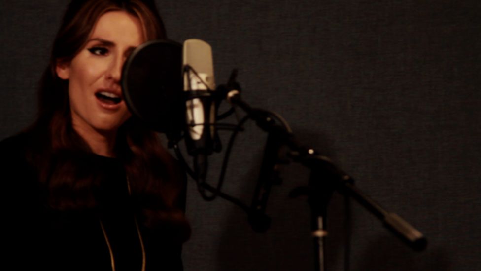 Disabled singer responds to childhood bullies in song - BBC News