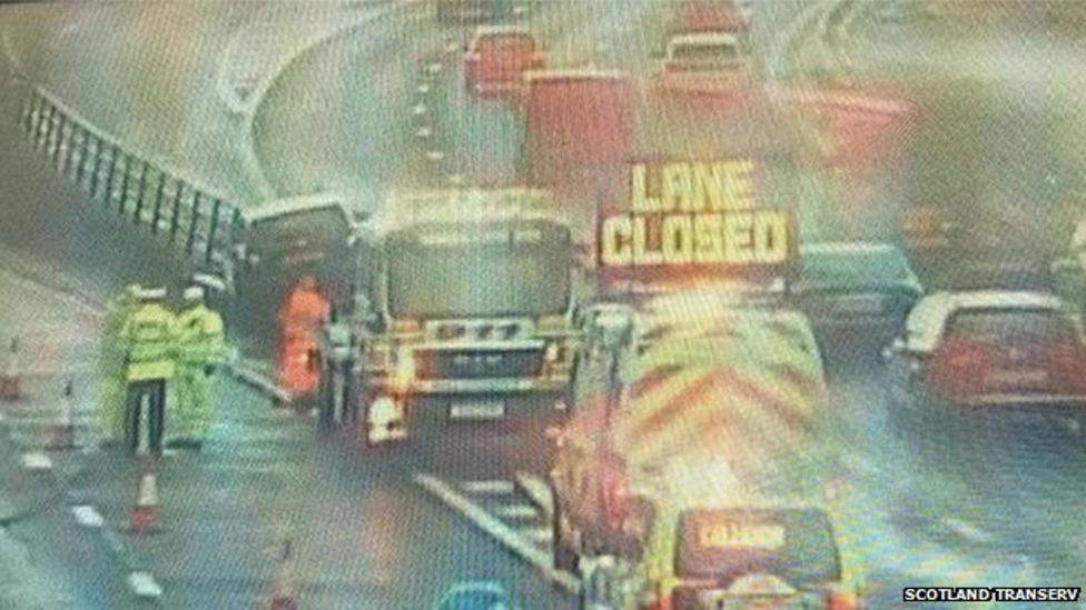 Car crashes and mounts central barrier on M8 motorway - BBC News