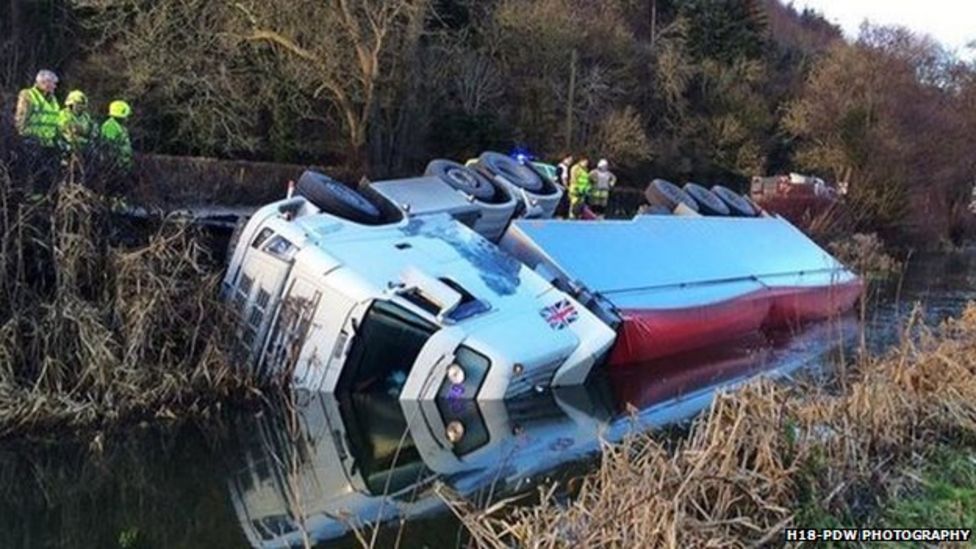 Tractor hanging off bridge closes A5 Chirk bypass, Wrexham - BBC News
