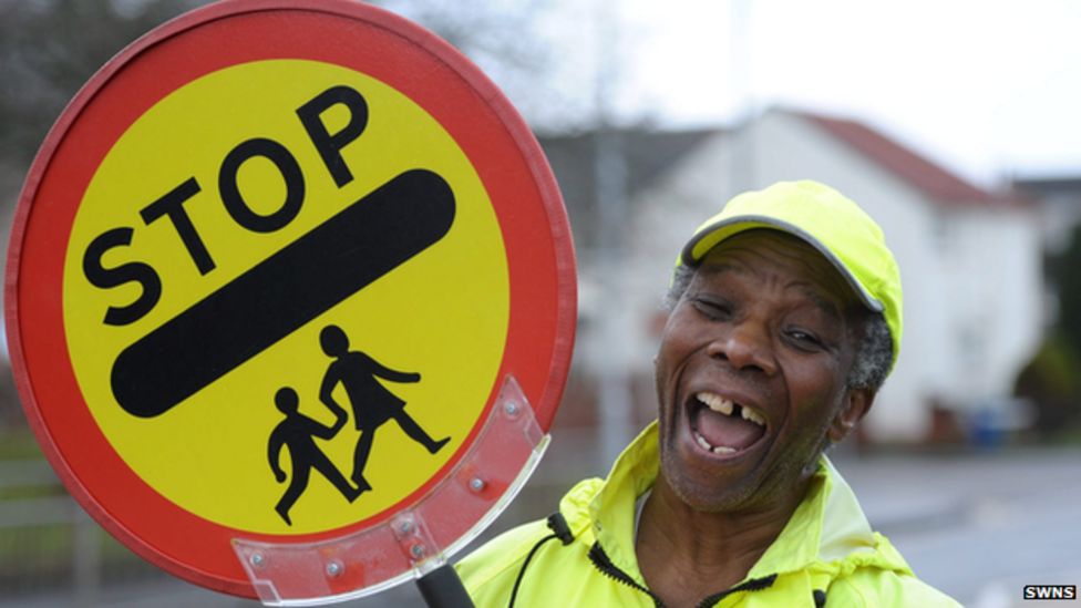 Council orders lollipop man to stop 'high-fiving' children - BBC News