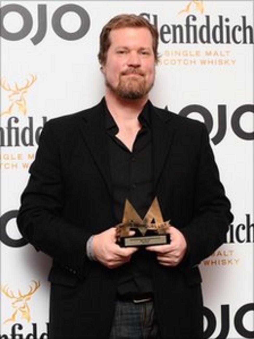 Singer John Grant uses newspaper as identity for passport - BBC News