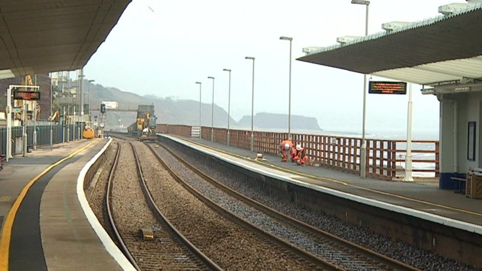 In pictures: Dawlish storm-hit railway line reopens - BBC News